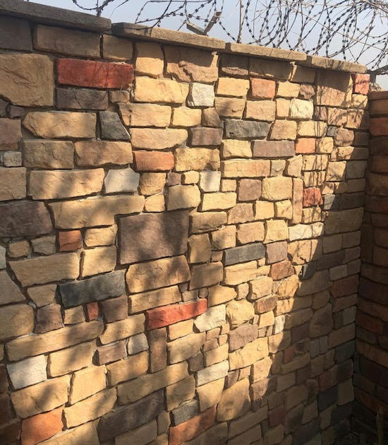 FENCE COMPLETLY COVERED IN COBBLE STONES