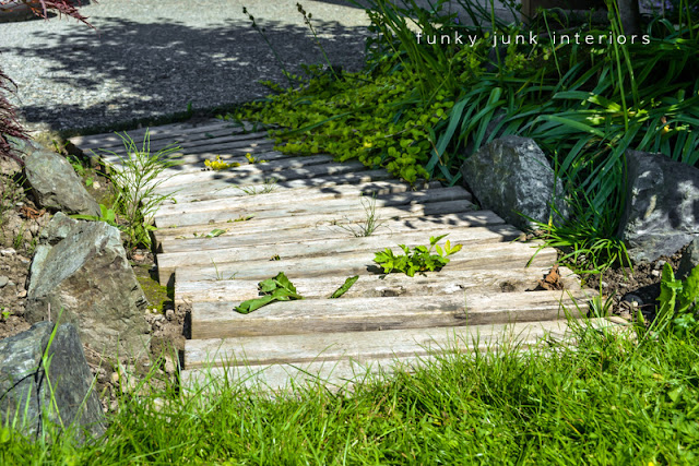 Pallet wood walkway 2 years later. Did it keep? Yes!Funky Junk Interiors