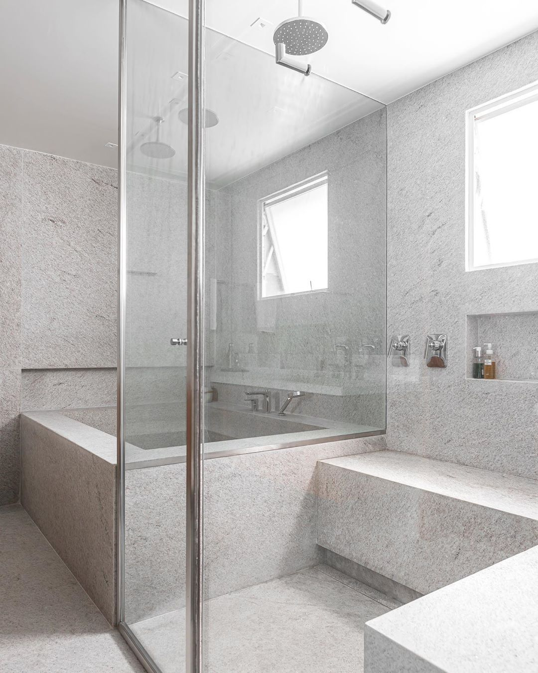 Banheiro com banheira todo revestido em granito siena escovado e ...