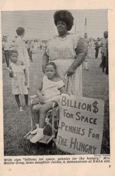 African-American woman and her disabled child protesting NASA rocket ...