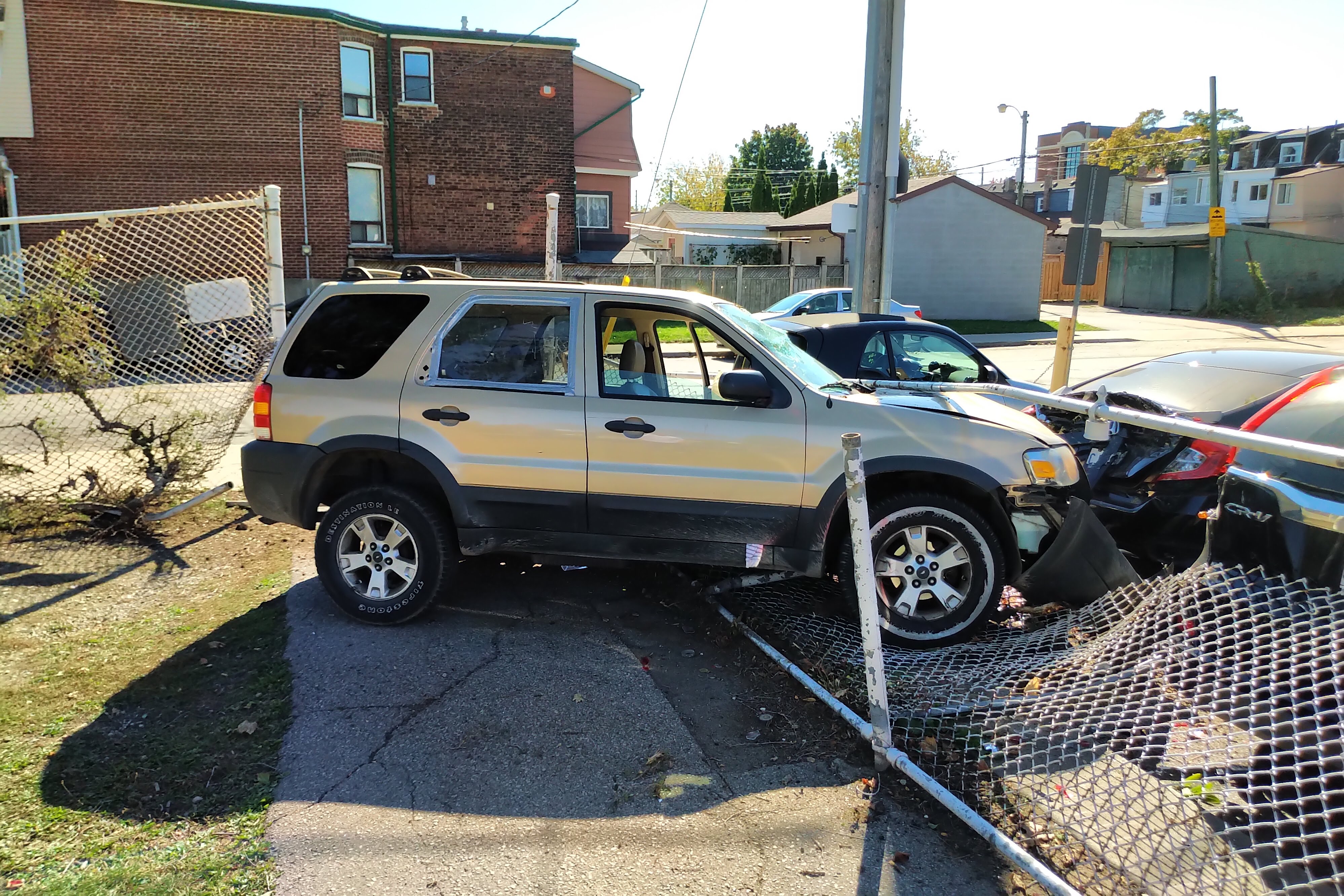Car in Toronto goes through stop sign, fence and crashes into parked ...