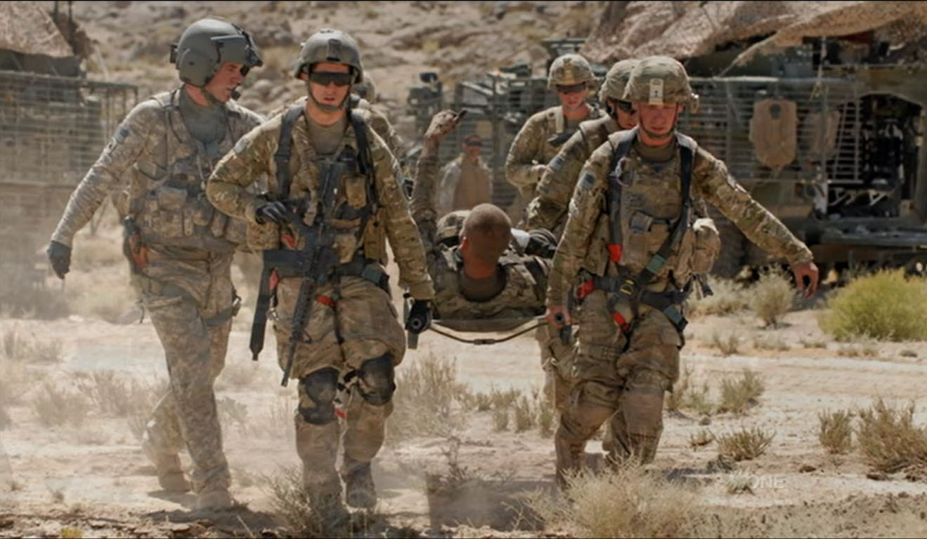 World Boat: Soldiers carry a wounded colleague, Afghanistan.