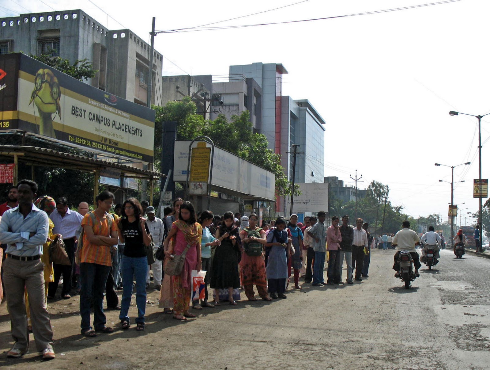 Stock Pictures: Waiting at a bus stop in India