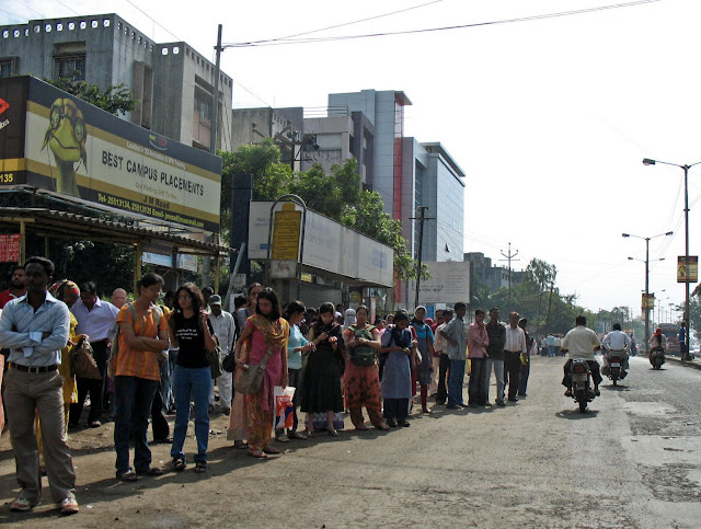 Stock Pictures: Waiting at a bus stop in India