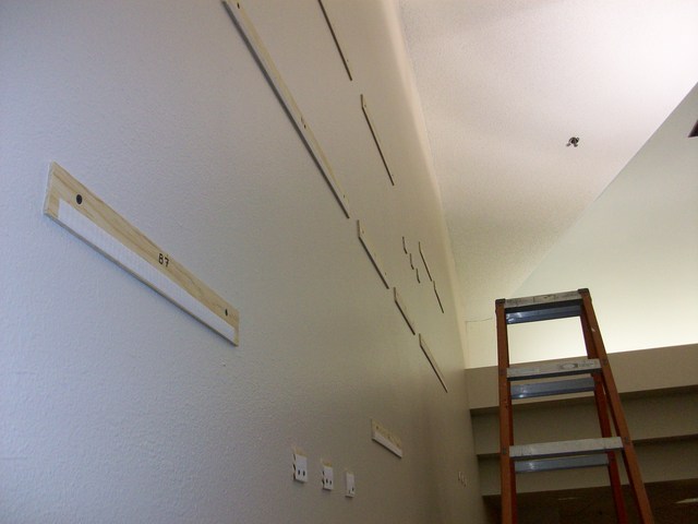 Dimensions: Wood strips screwed to the wall offer support for the frames