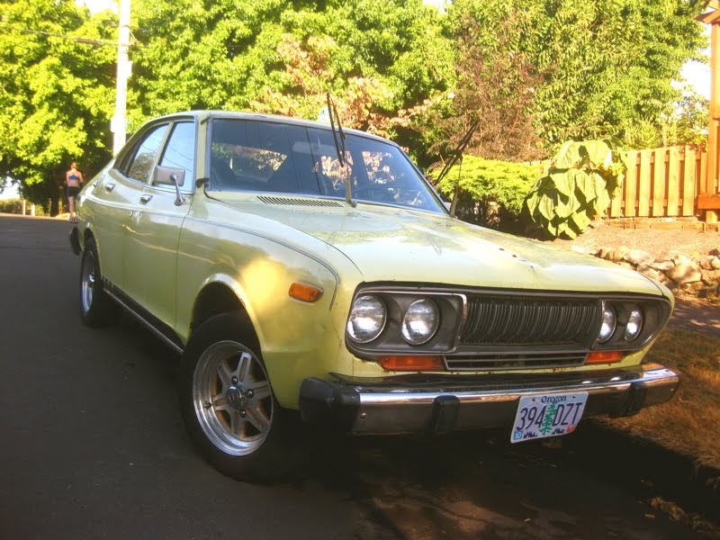OLD PARKED CARS.: 1975 Datsun 710 4-Door Fastback.
