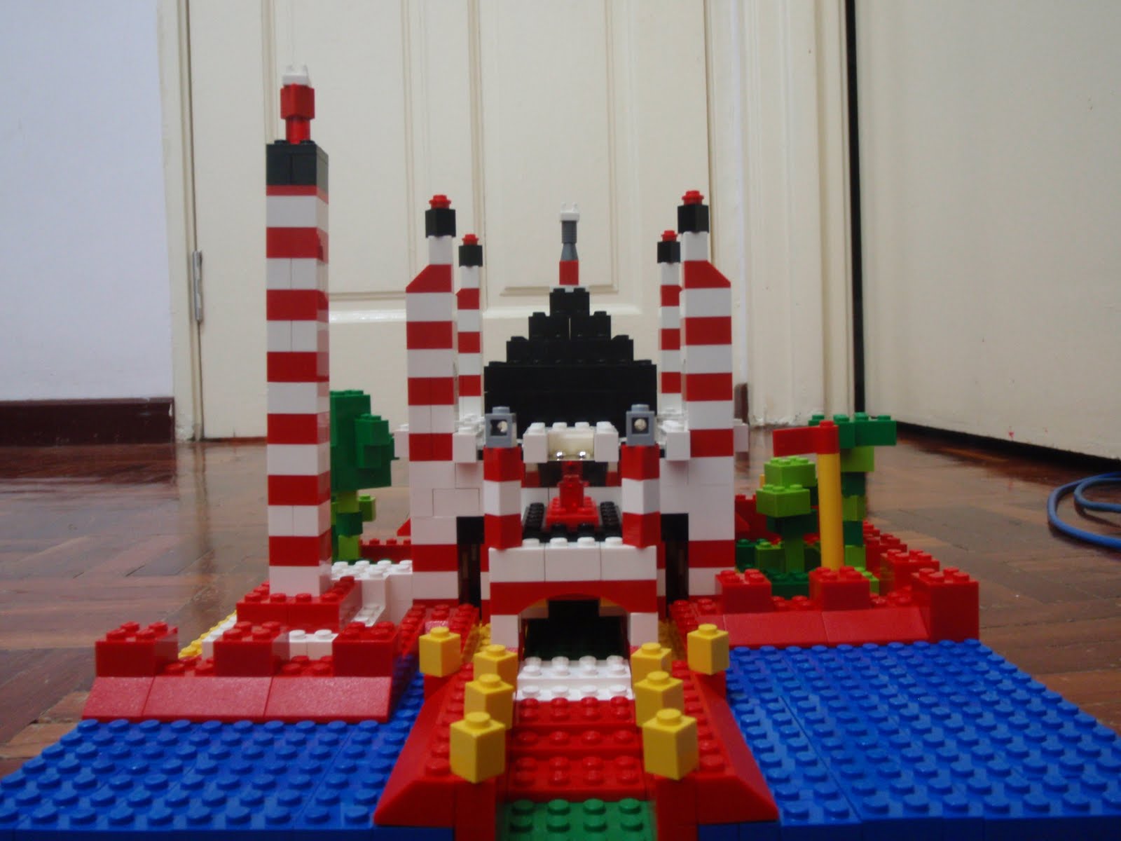 BUANASENI: RED & WHITE MOSQUE WITH A BLACK DOME