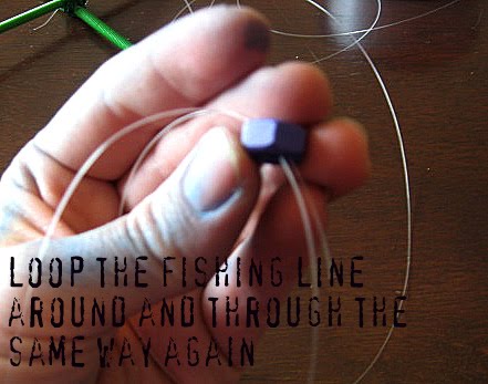 23. Thread the end of the fishing line through one of the flowers and ...
