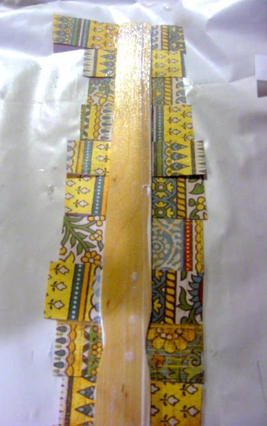 Fold down each strip on one side of the stick.